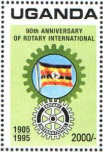 Stamp: Rotary emblem and flag (Uganda(Rotary International, 90th ...